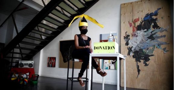 Paris gallery enforces social distancing by giving visitors winged hats ...