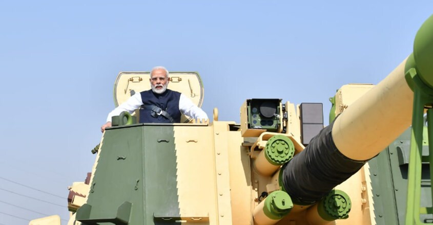 Modi boards tank at L&T's gun-making facility in Gujarat