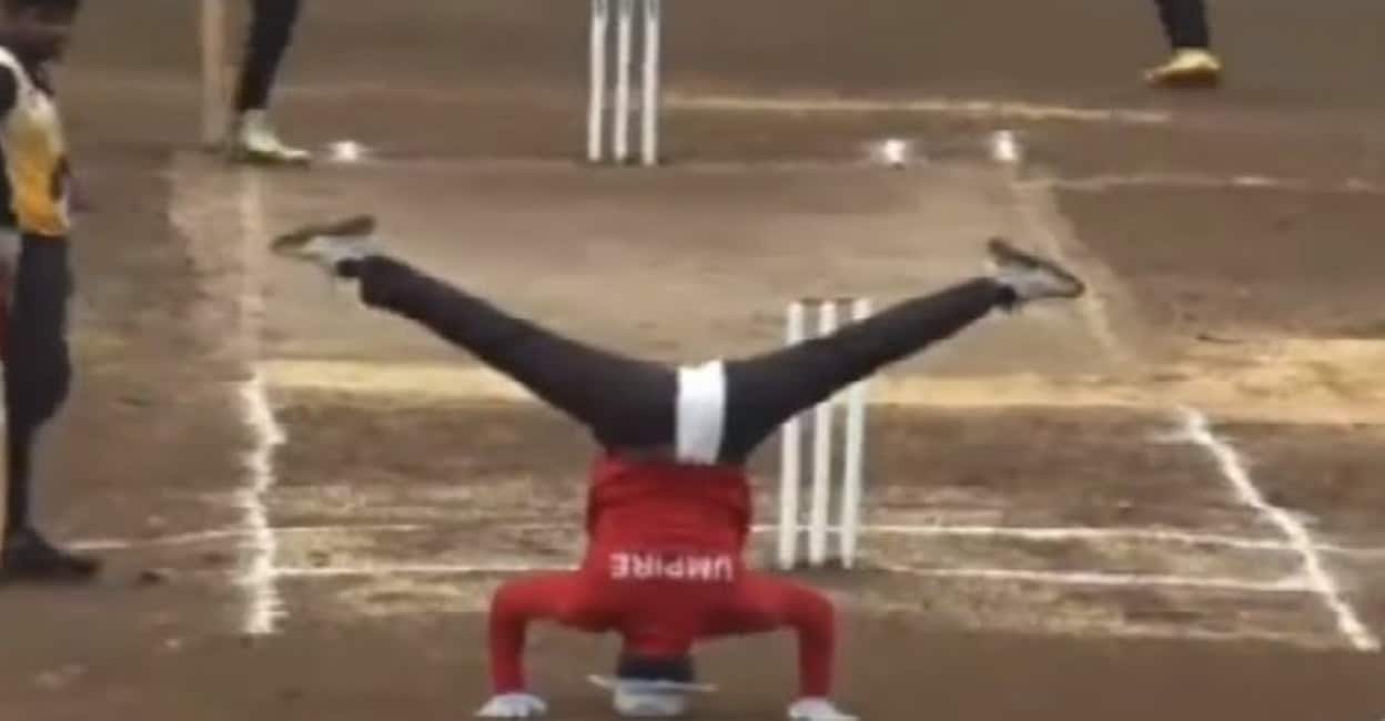 Head down, legs up! Umpire's unique wide signal goes viral | Video ...